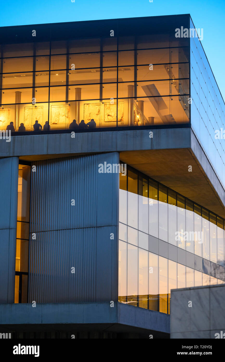 Visitors looking at the Parthenon marbles, seen through the windows of ...