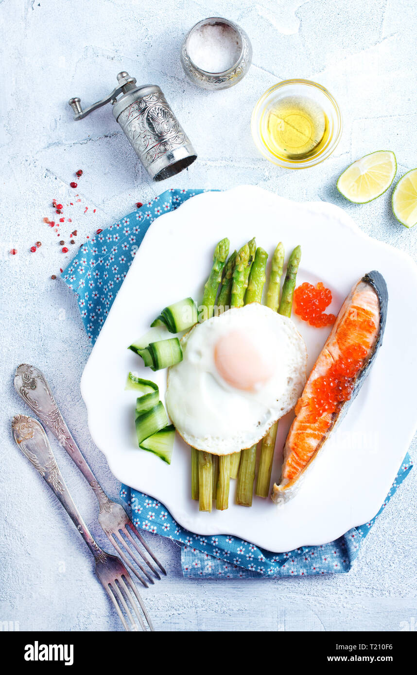 breakfast, fried fish with asparagus and egg Stock Photo - Alamy