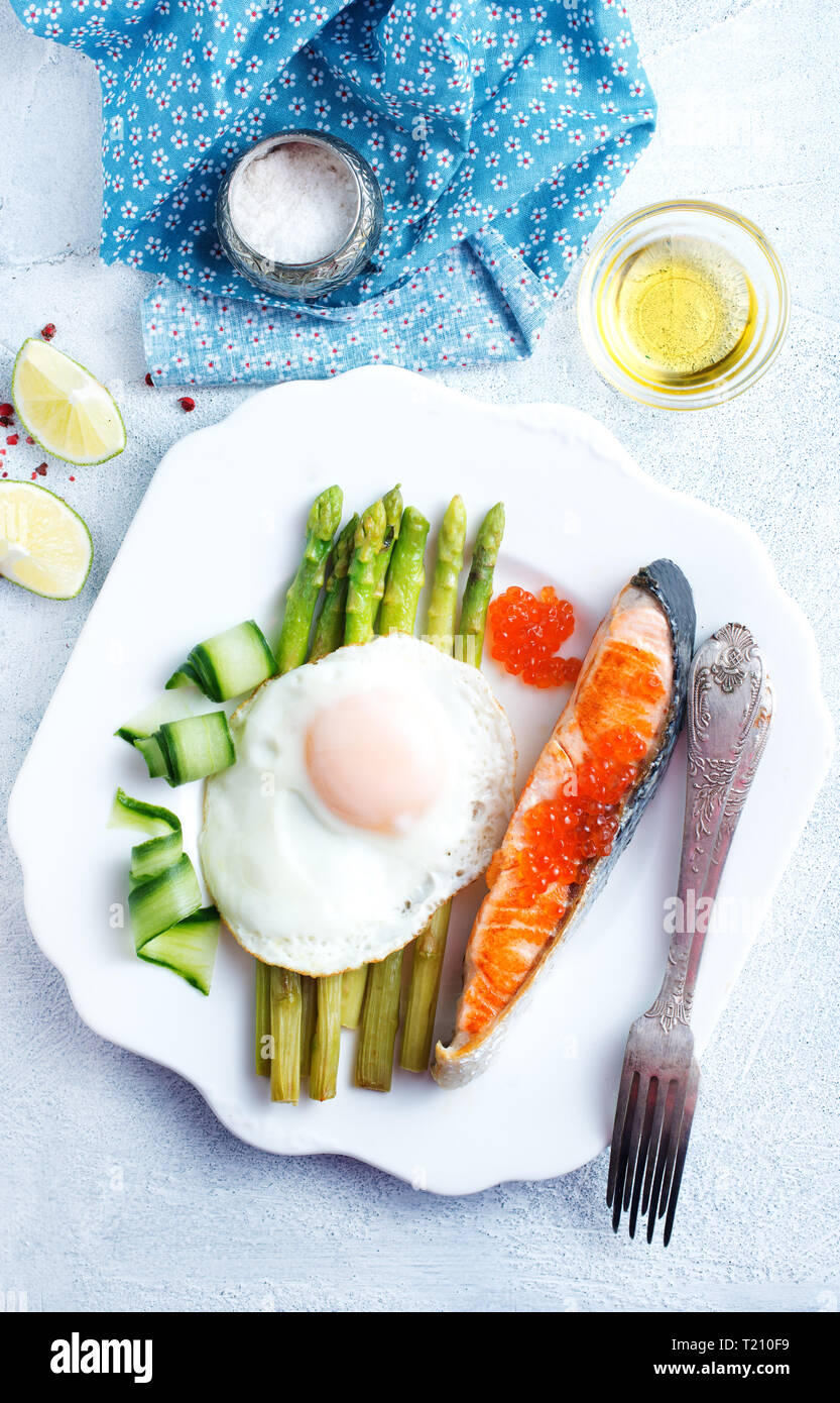breakfast, fried fish with asparagus and egg Stock Photo - Alamy