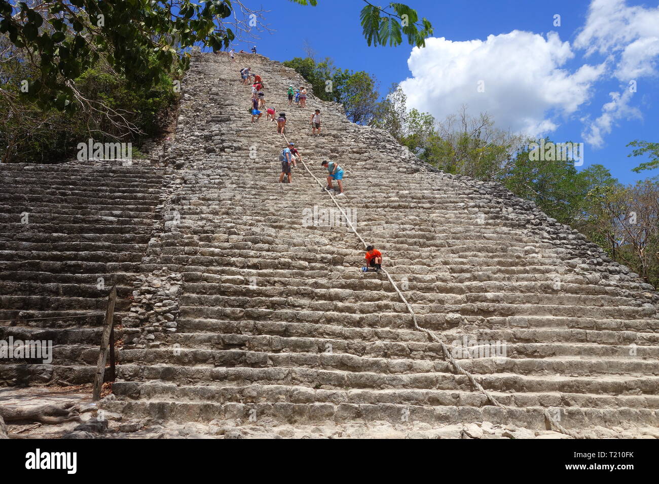 Travelers climbing the Mayan Ruins of Coba in Quintana Roo, Mexico ...
