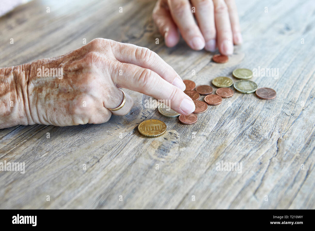Counting coins hi-res stock photography and images - Alamy