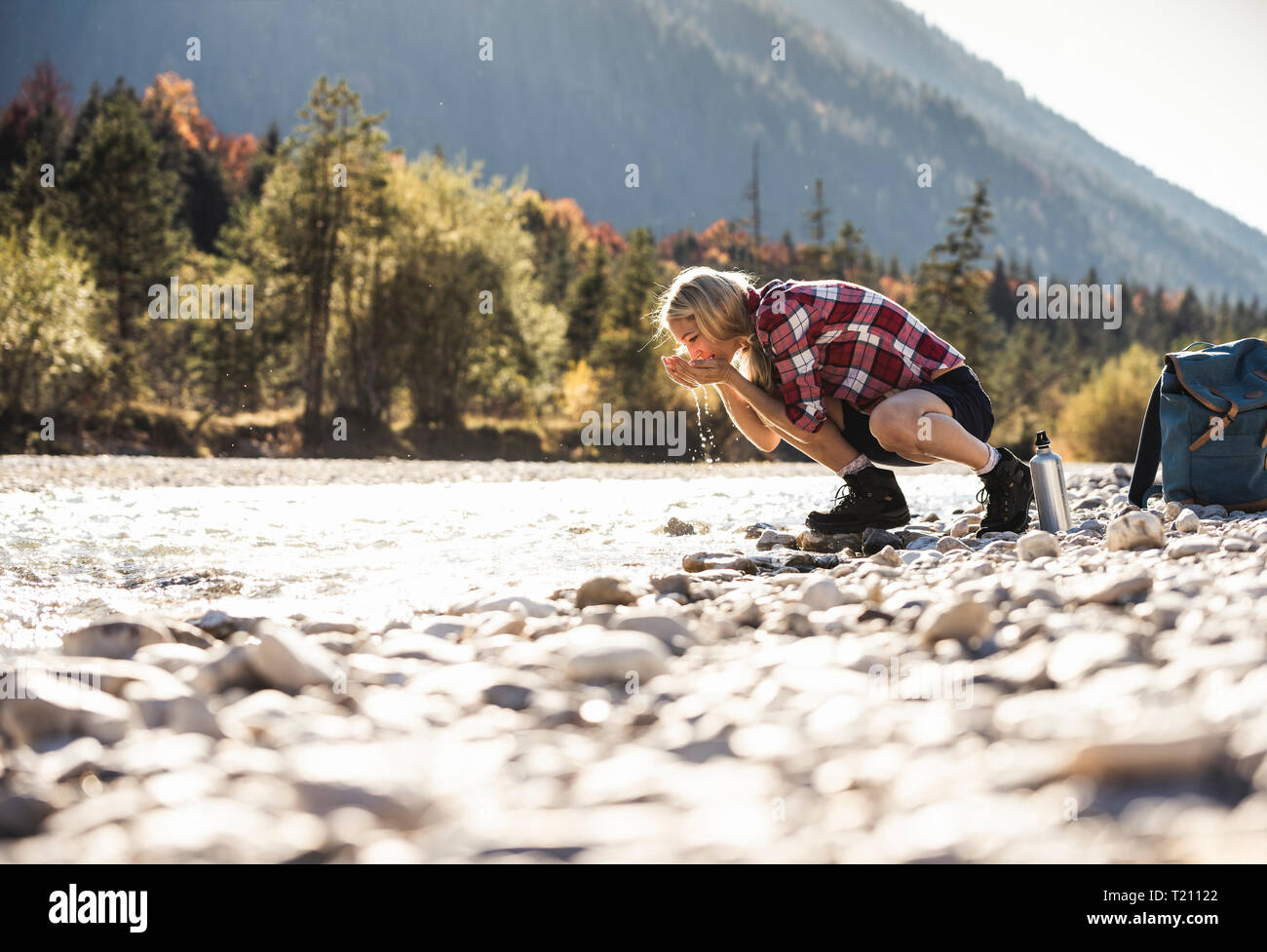 Austria, Alps, woman on a hiking trip having a break at a brook Stock ...