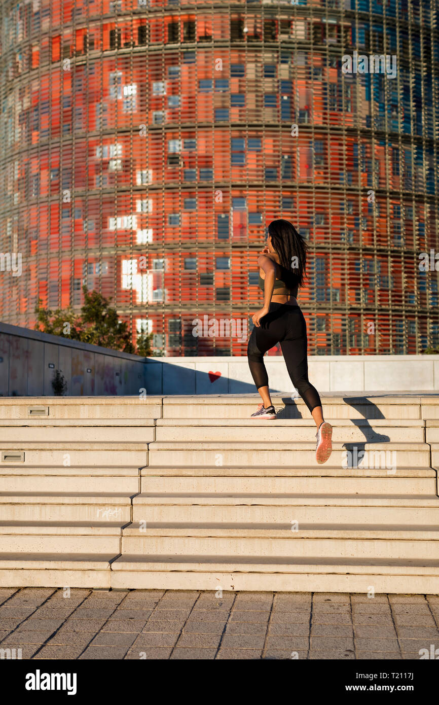 Young woman running up stairs hi-res stock photography and images - Alamy
