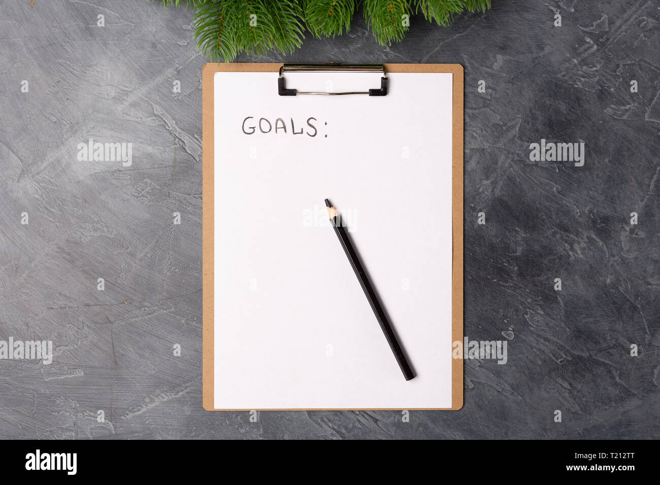 Blank paper with goals title and black pencil on grey table. Flat lay ...