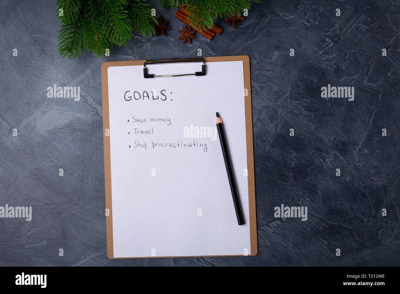 Paper with list of goals and black pencil on grey table. Flat lay. Top ...