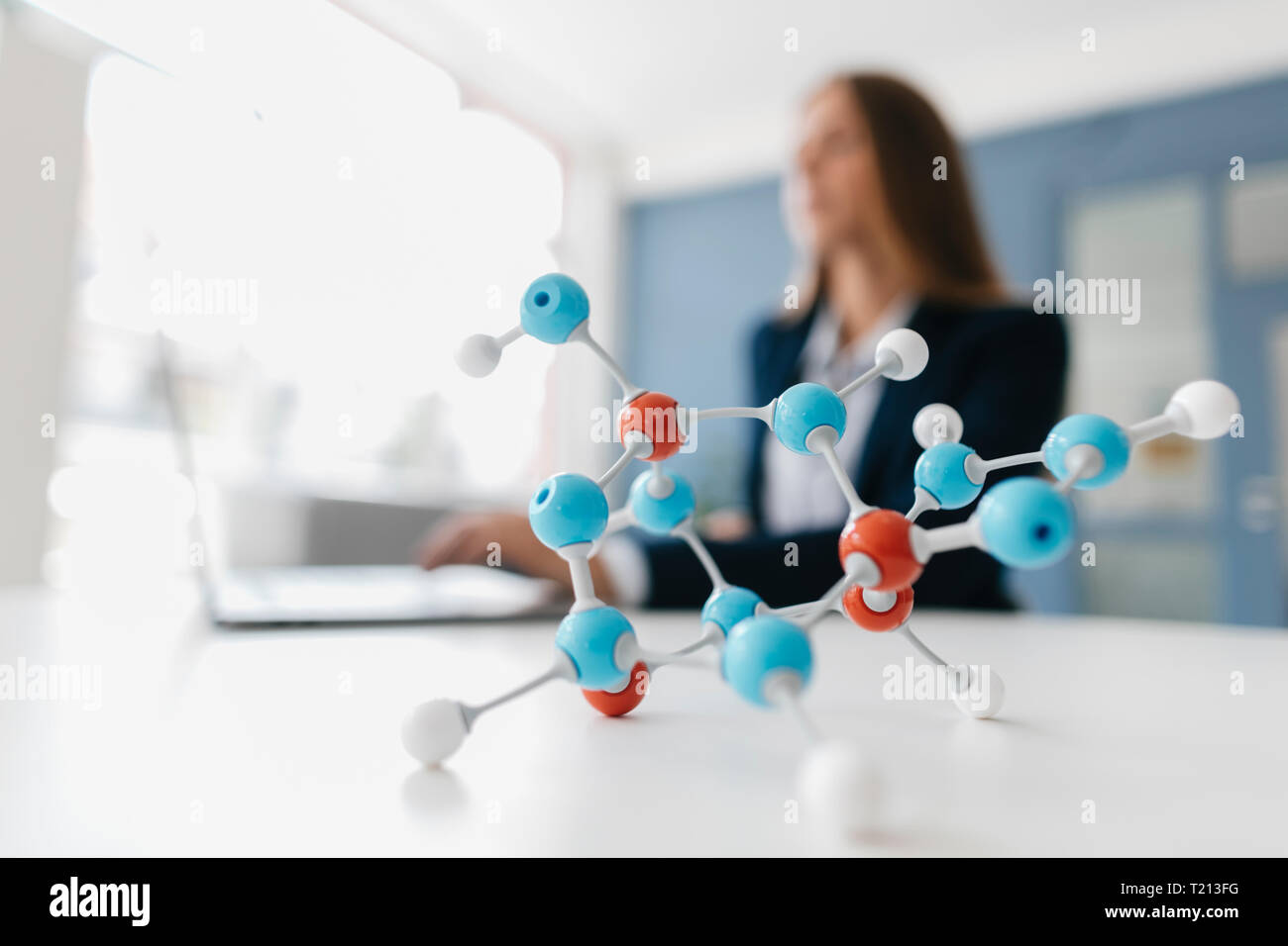Female scientist studying molecule model Stock Photo - Alamy