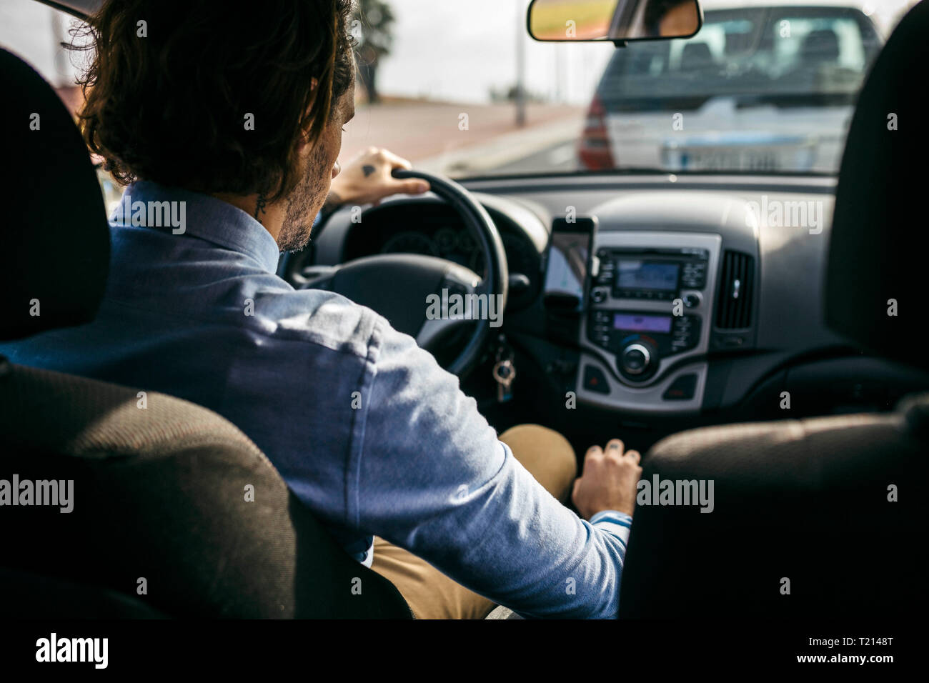Rear view of businessman driving car Stock Photo - Alamy