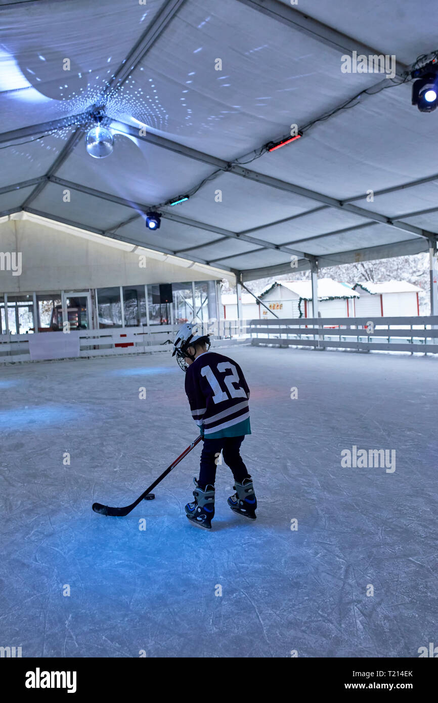 Boy playing ice hockey on the ice rink Stock Photo - Alamy