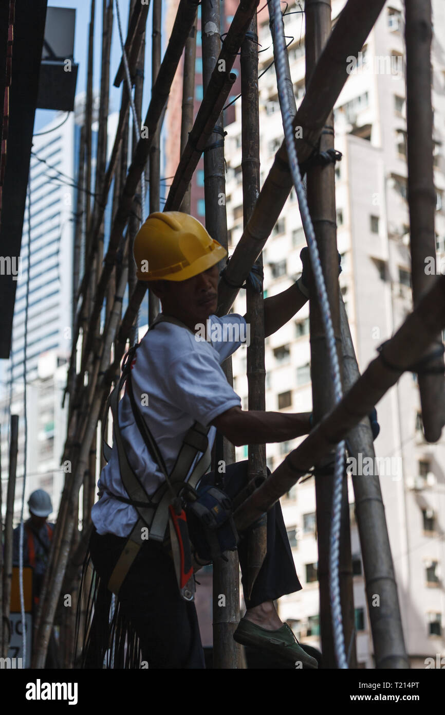 Portrait of a Chinese construction worker with yellow hard hat on ...