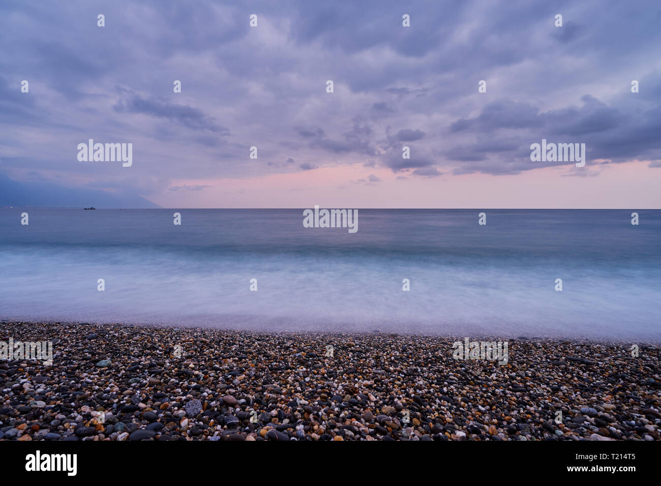 Beautiful scenic of ocean with sprawling stone covered beach at ...