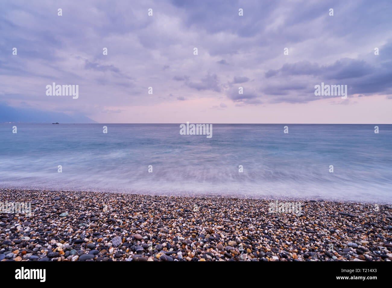 Beautiful scenic of ocean with sprawling stone covered beach at ...