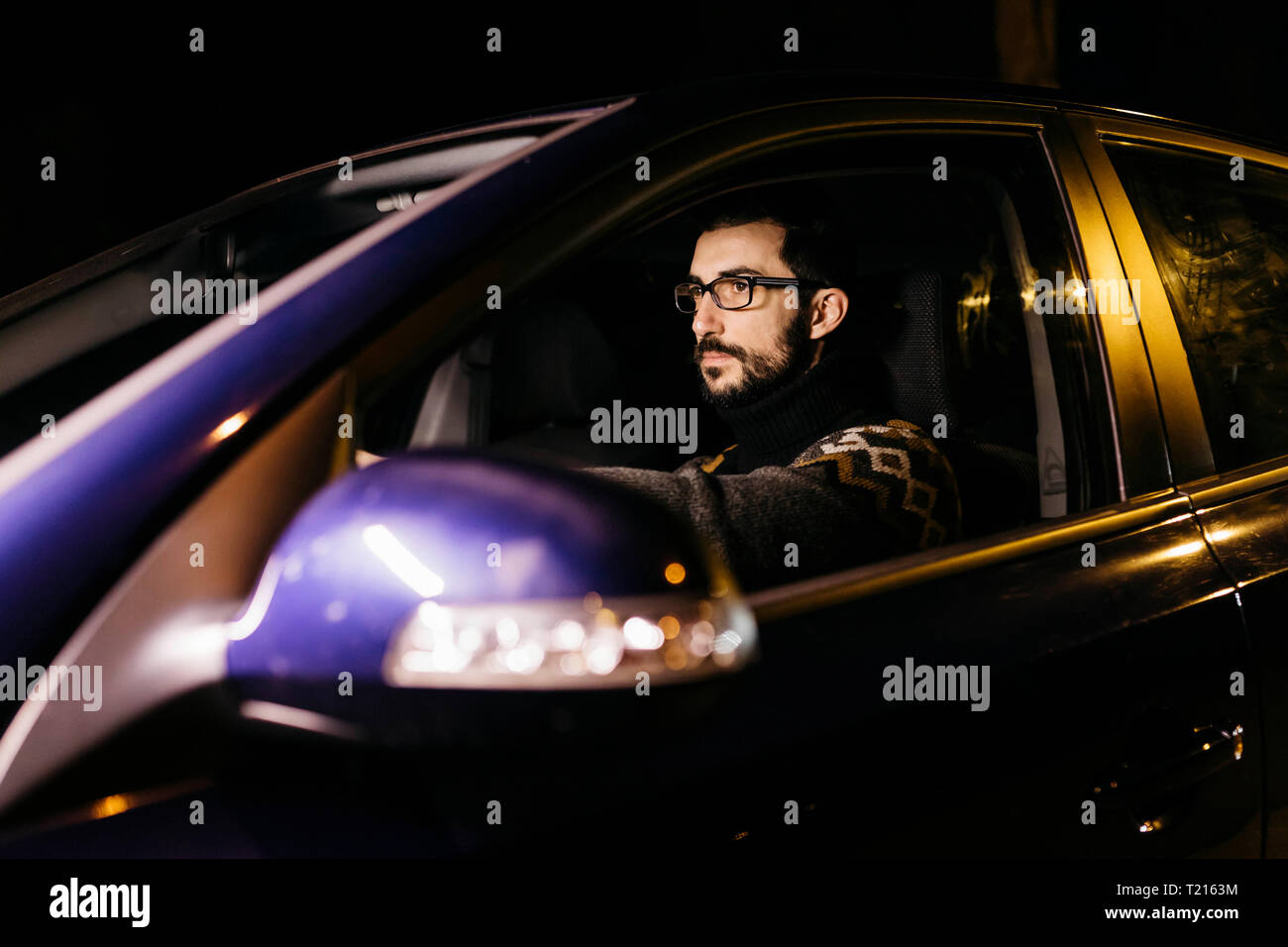 Man driving car at night Stock Photo - Alamy