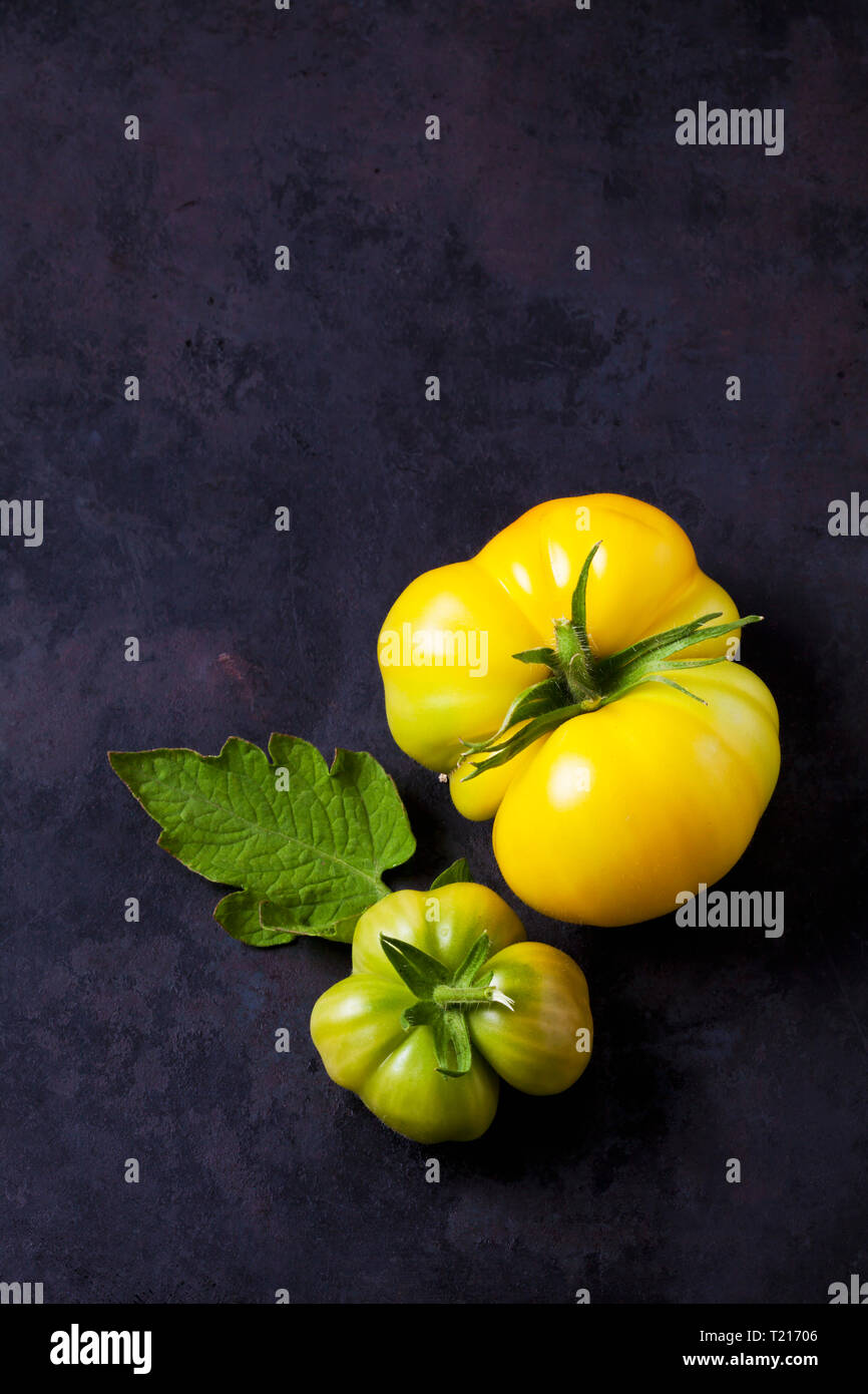 Two Azoychka tomatoes on dark ground Stock Photo - Alamy