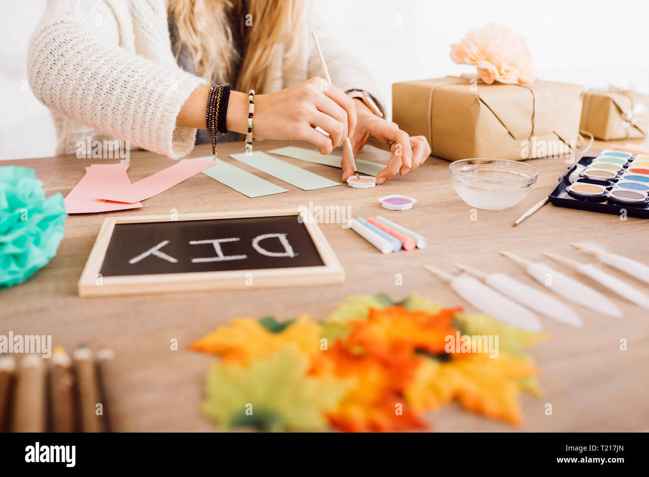 Young woman doing crafts with watercolour in her studio Stock Photo - Alamy