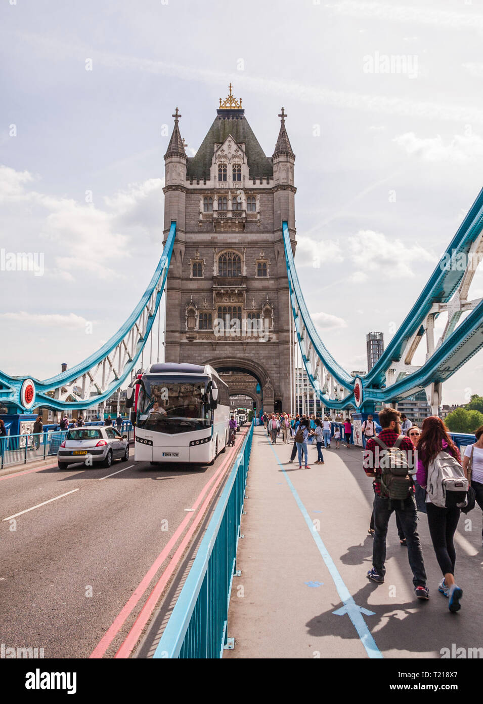 A view of pedestrians and traffic crossing Tower Bridge on a sunny day ...