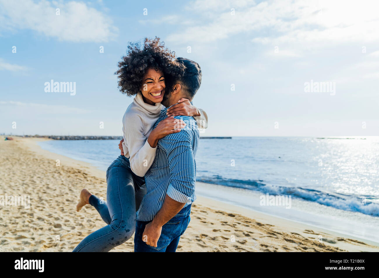 Spain, Barcelona, happy couple hugging on the beach Stock Photo - Alamy