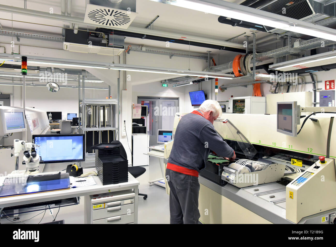 Man working on the manufacturing of circuit boards for the electronics ...