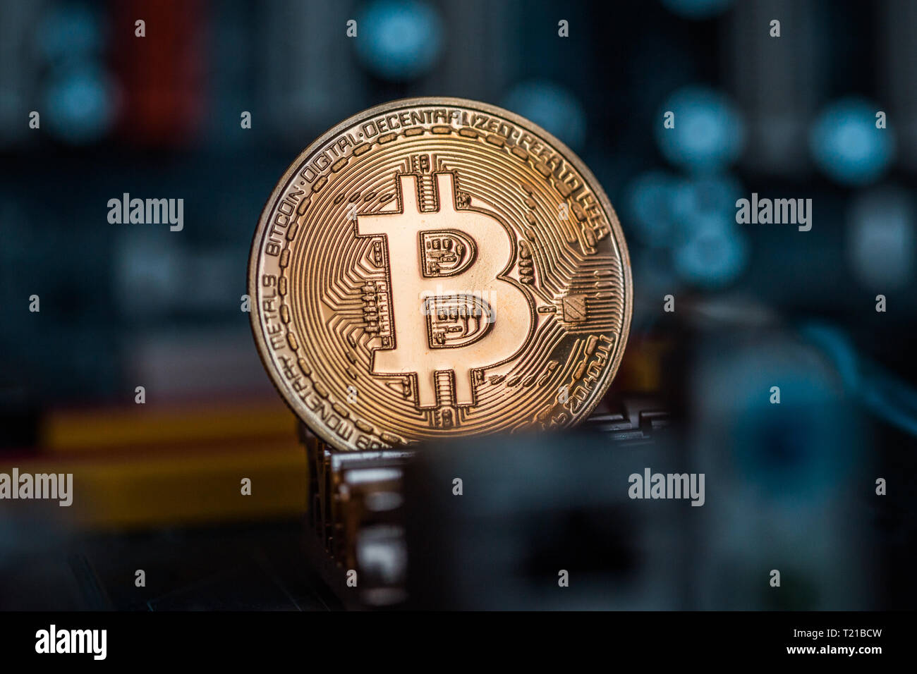 Golden Bitcoin Cryptocurrency on a computer board. Macro shooting. The ...