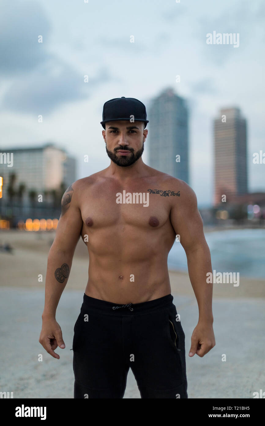 Portrait of barechested muscular man outdoors at dusk Stock Photo - Alamy