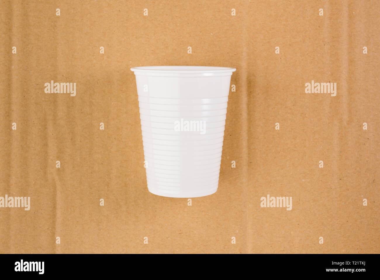 Cardboard sheet of paper,abstract texture background with plastic cup ...
