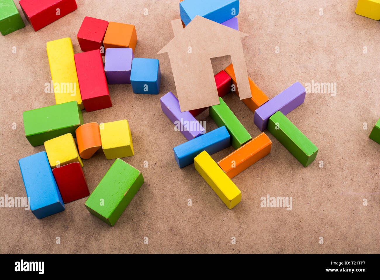 House shape formed out of building blocks on a brown background Stock ...