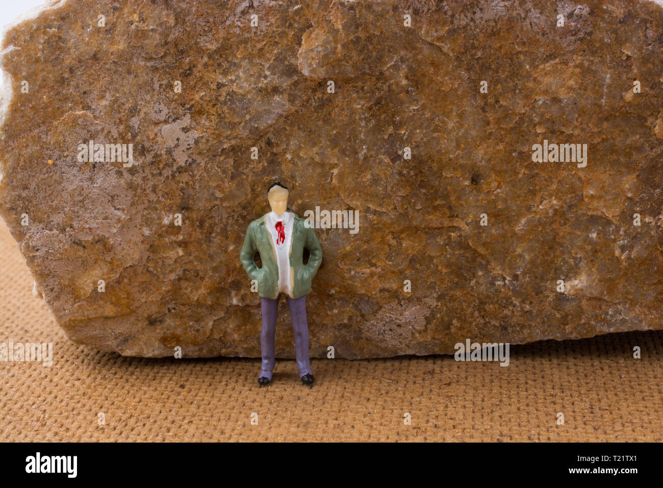 Human figure on rock on a white background Stock Photo - Alamy