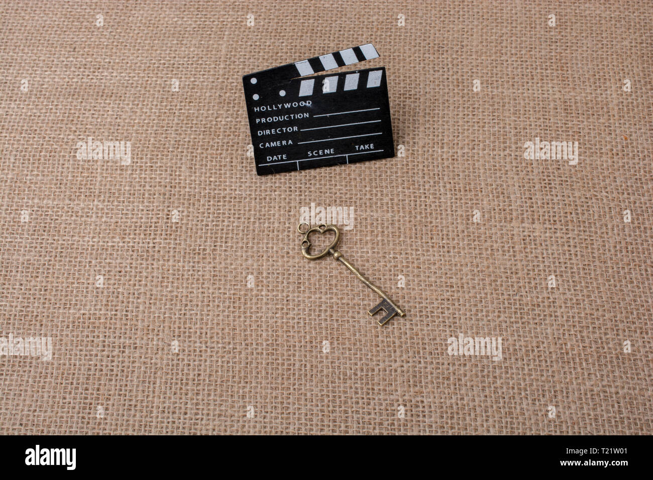 Movie clapper and retro key on canvas background Stock Photo - Alamy