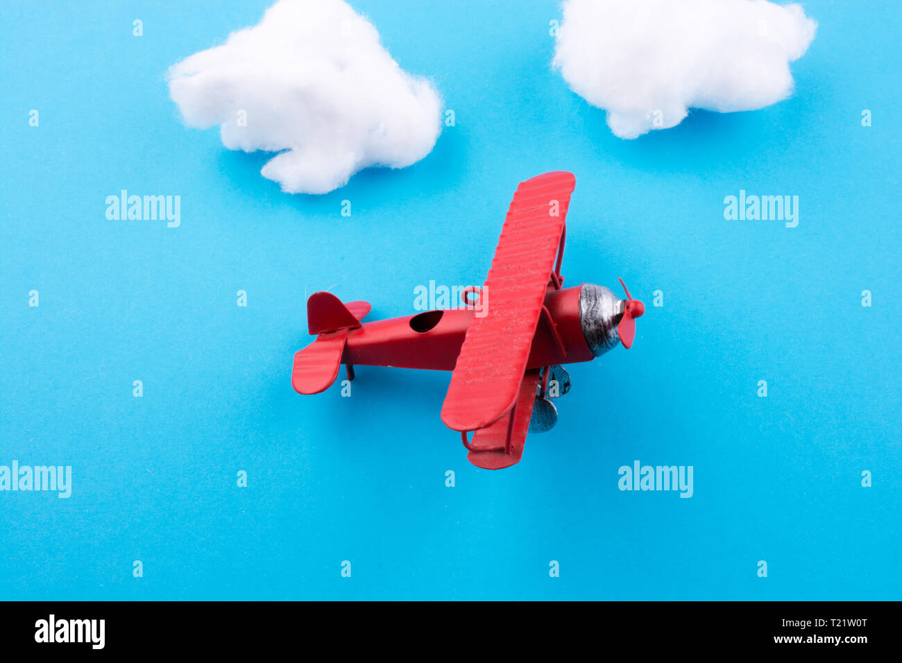 Retro styled little red model airplane in sky Stock Photo - Alamy