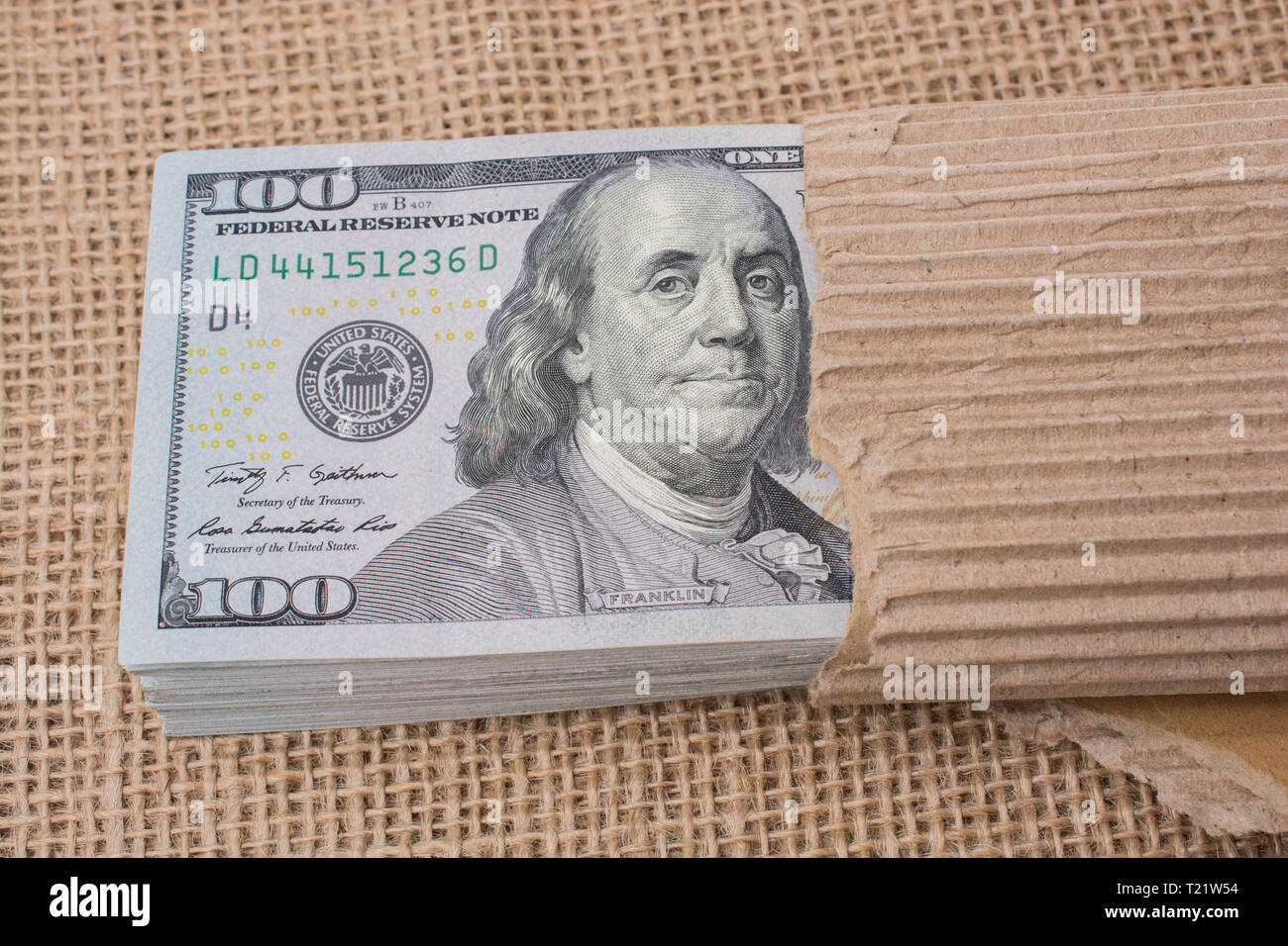 Banknote bundle of US dollar partly wrapped in cardboard Stock Photo ...