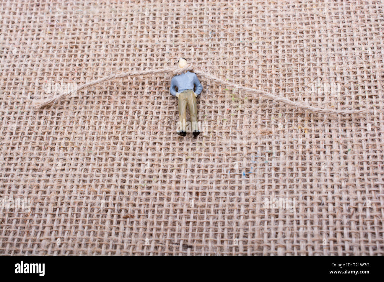 Figurine man with a rope on the neck Stock Photo - Alamy