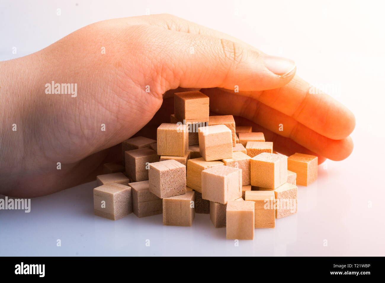 Hand playing with wooden cubes as educational and business concept ...