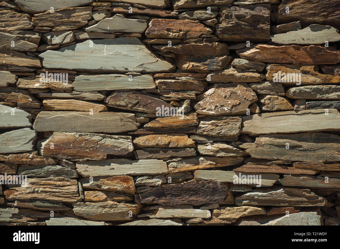 Wall made of rough slate stone making a quaint pattern at the Monfrague ...