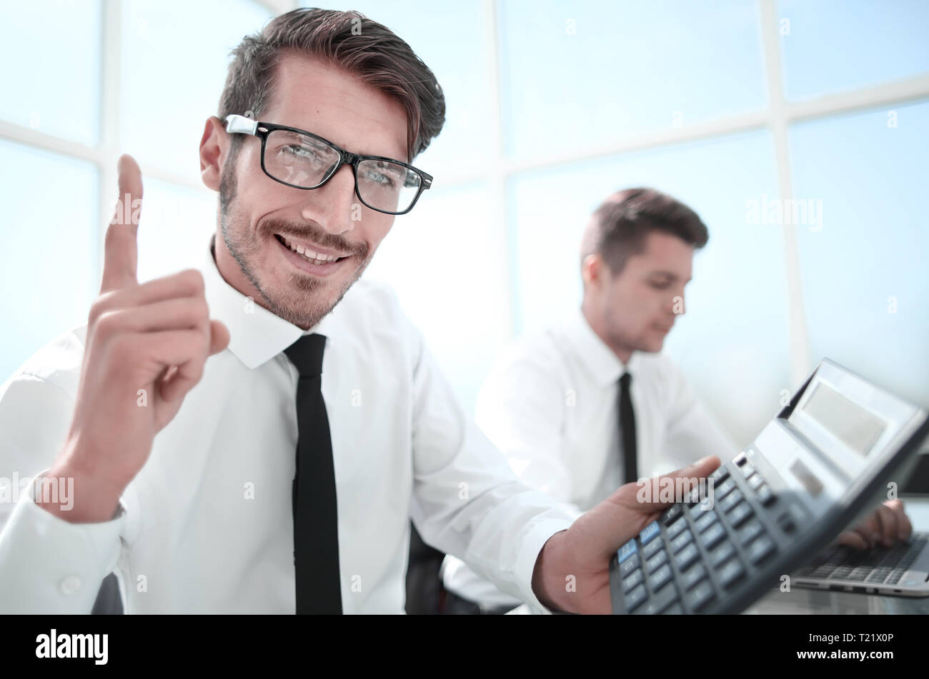 young accountant holding a thumb up and smiling Stock Photo - Alamy