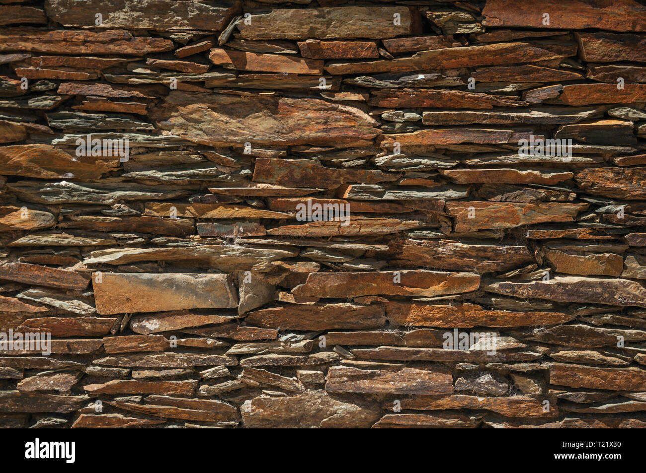 Wall made of rough slate stone making a quaint pattern at the Monfrague ...