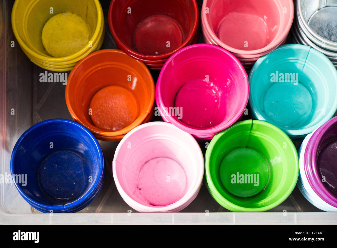 Little set of buckets of various colors in a market place Stock Photo ...