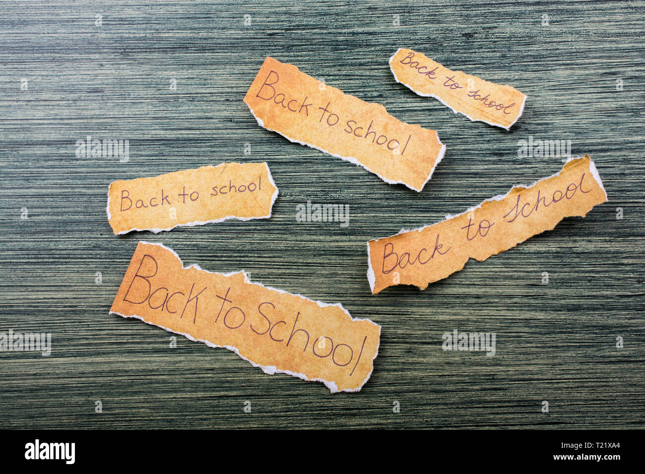 Back to school wording on a piece of torn paper Stock Photo - Alamy