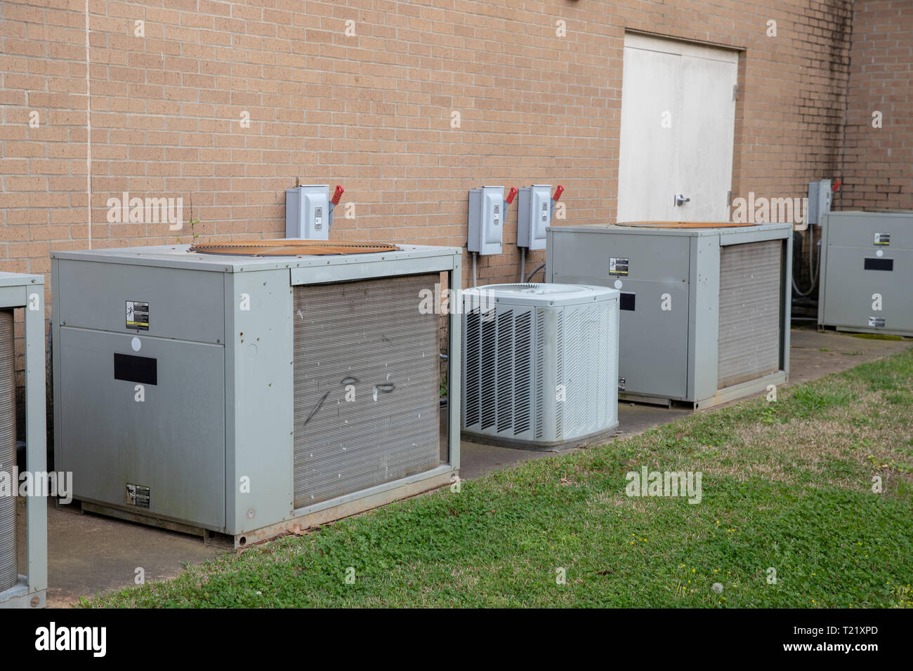 Multiple Commerical Air Conditioner Compressors outside brick building ...