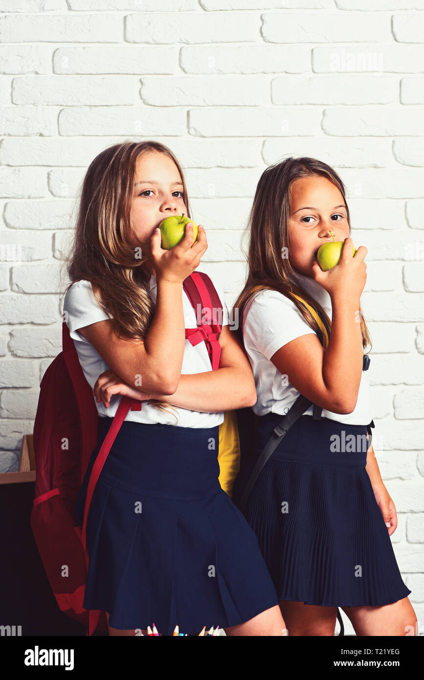 Back to school and happy time Cute children eating apples. Kids are ...