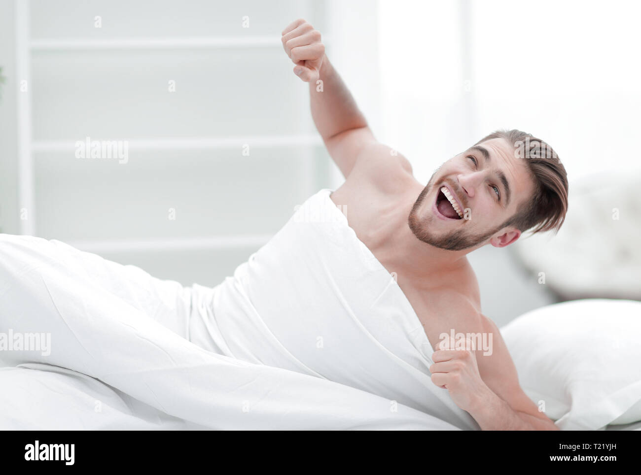 smiling man waking up in the morning Stock Photo - Alamy