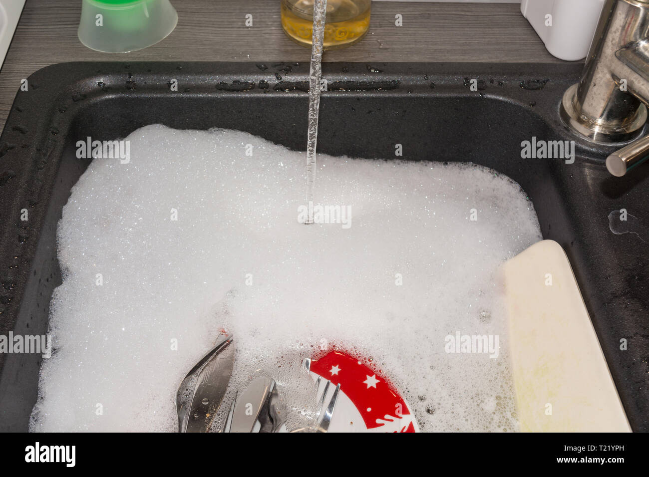 Wash and dry kitchen utensils on the sink by hand Stock Photo - Alamy