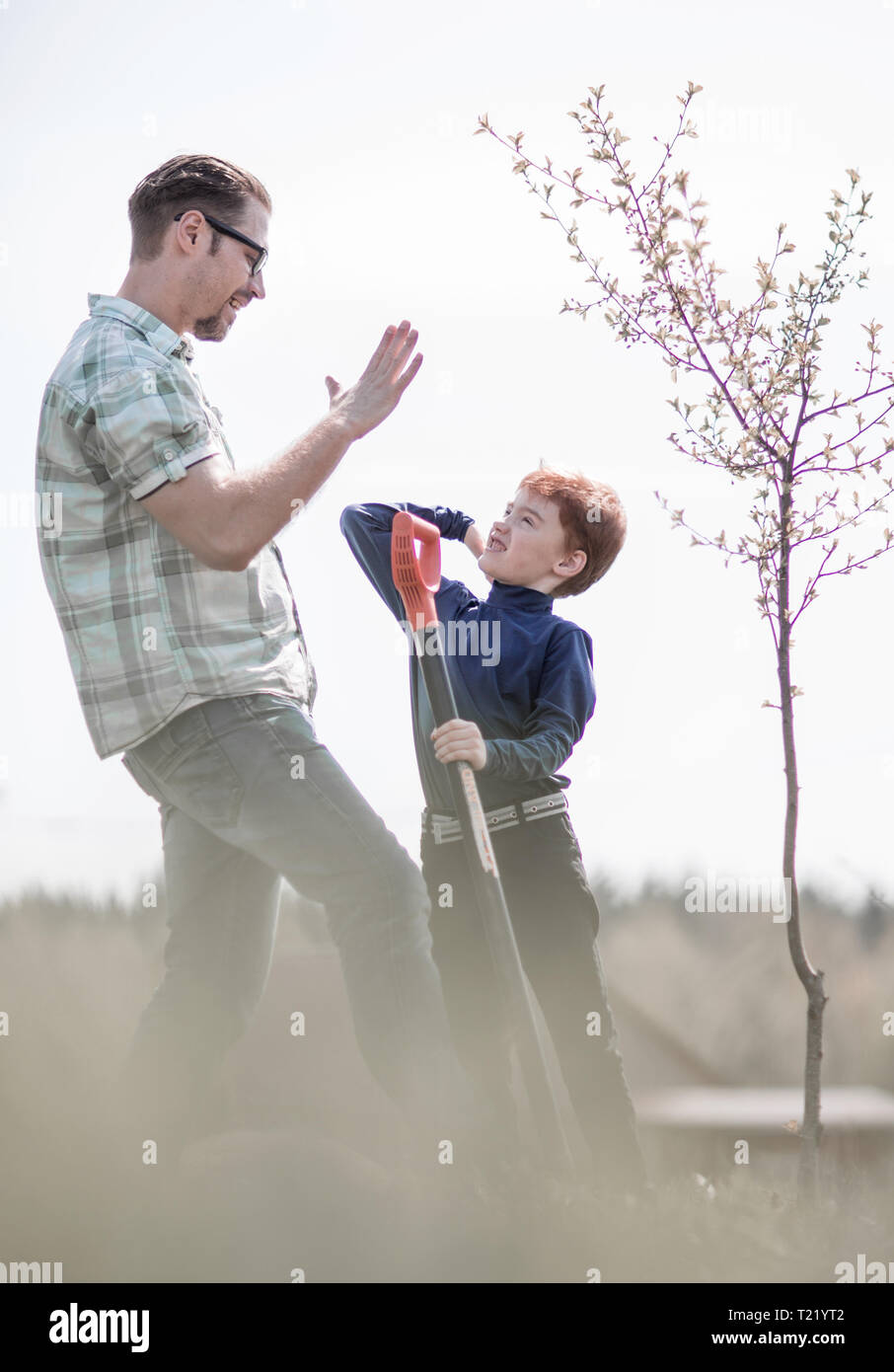 Father son planting tree hi-res stock photography and images - Alamy