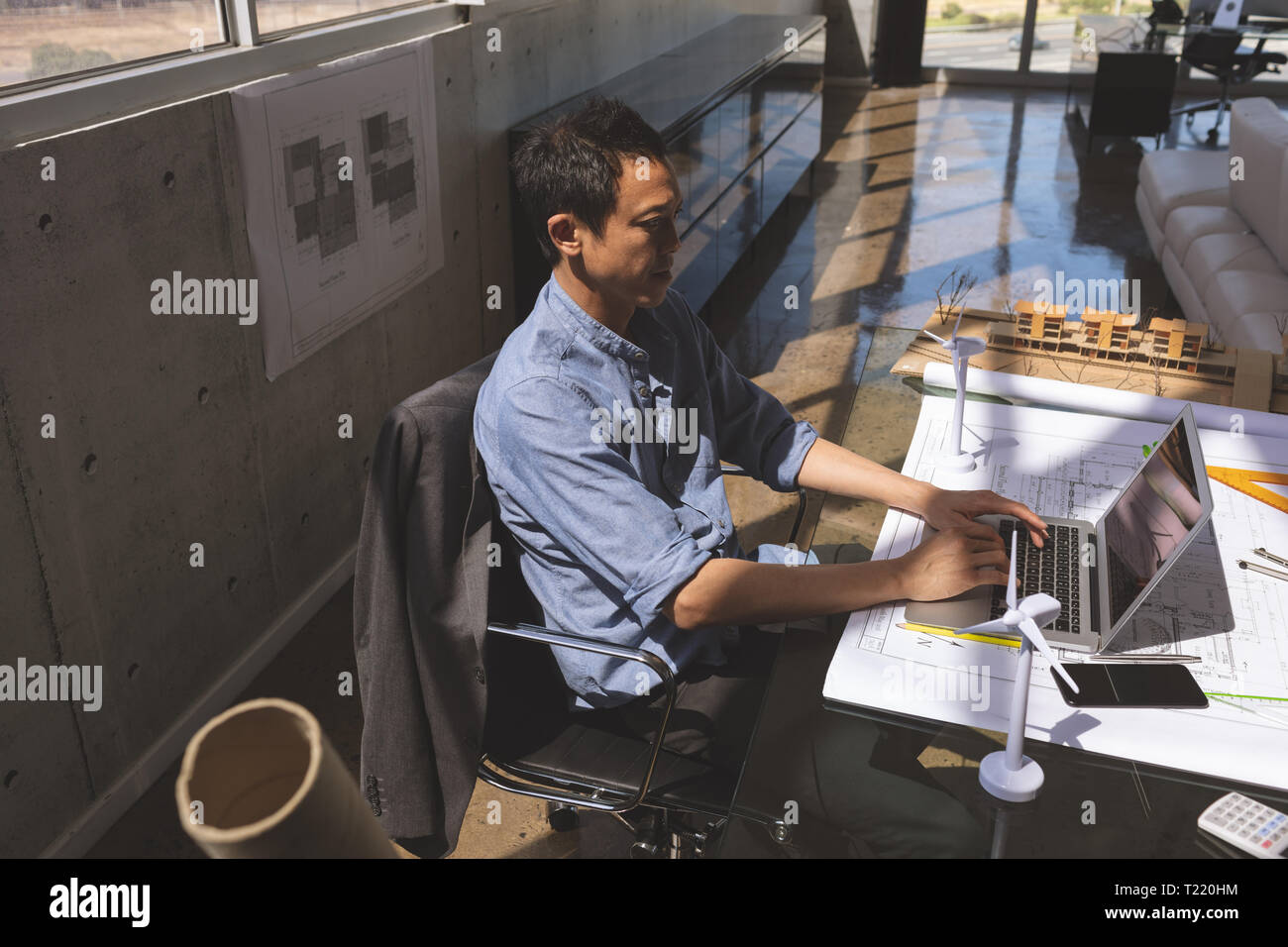 Male executive using laptop in the office Stock Photo - Alamy