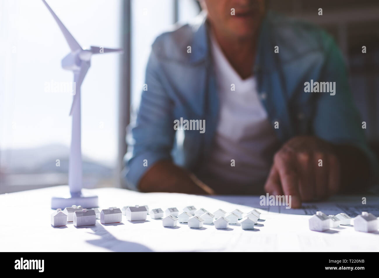 Male architecture working on architectural model at desk Stock Photo ...