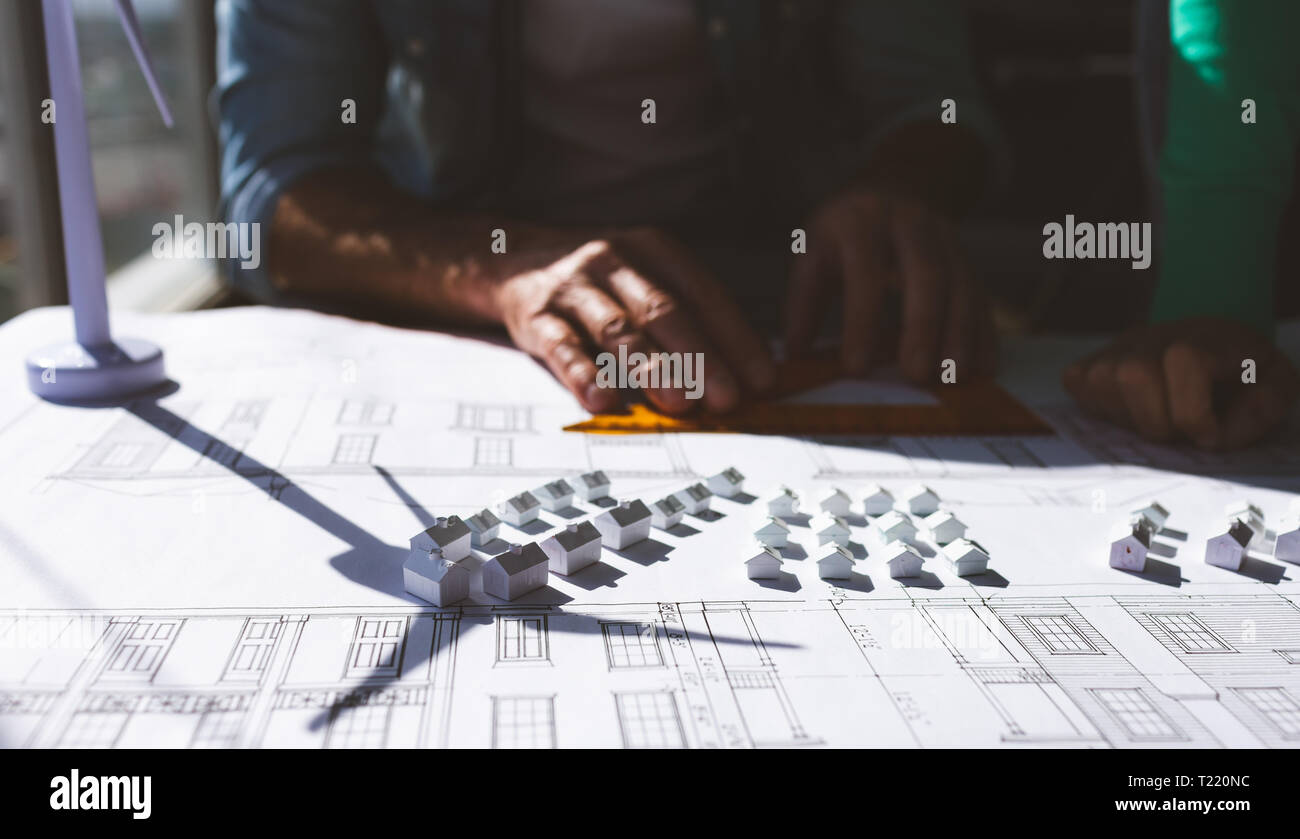 Male architecture working on architectural model at desk Stock Photo ...