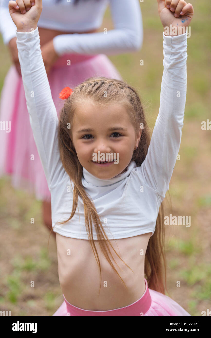 Little girl playing in the sun, raising hands Stock Photo - Alamy