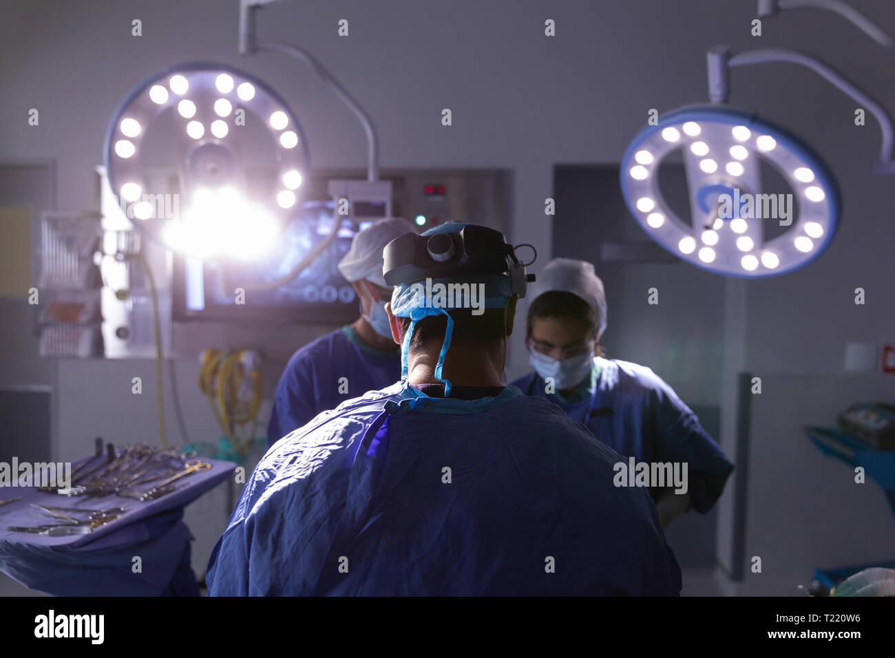 Surgeons performing operation in operating room at hospital Stock Photo ...
