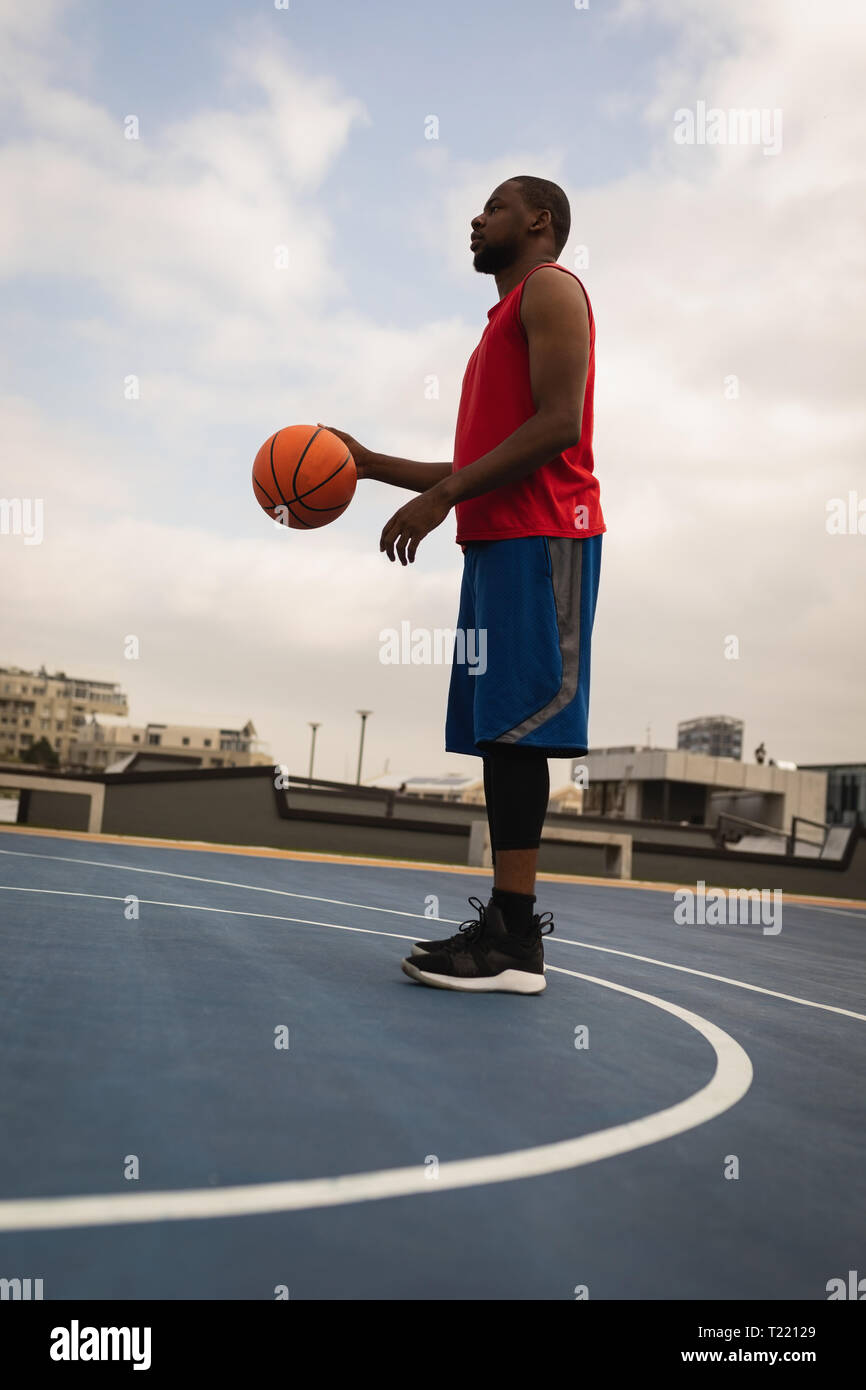 Basketball player playing basketball at basketball court Stock Photo ...