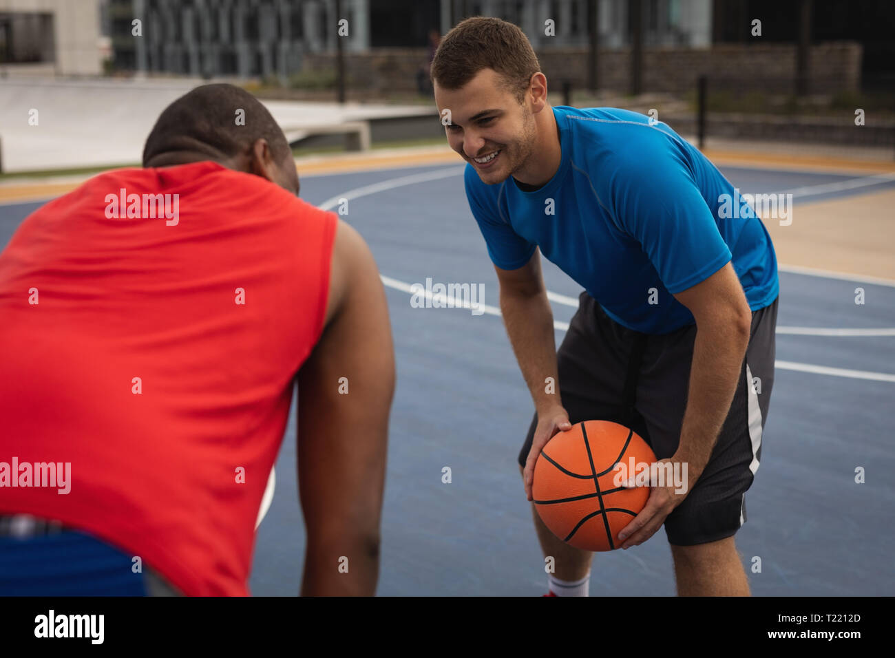Basketball players interacting with each other while playing basketball ...