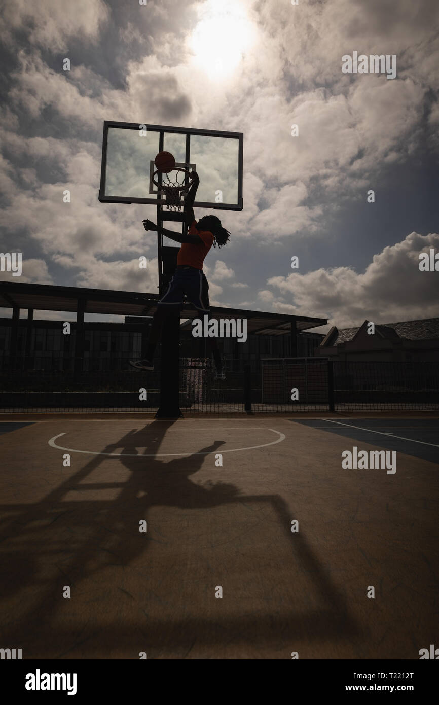 Basketball player playing basketball at basketball court Stock Photo ...