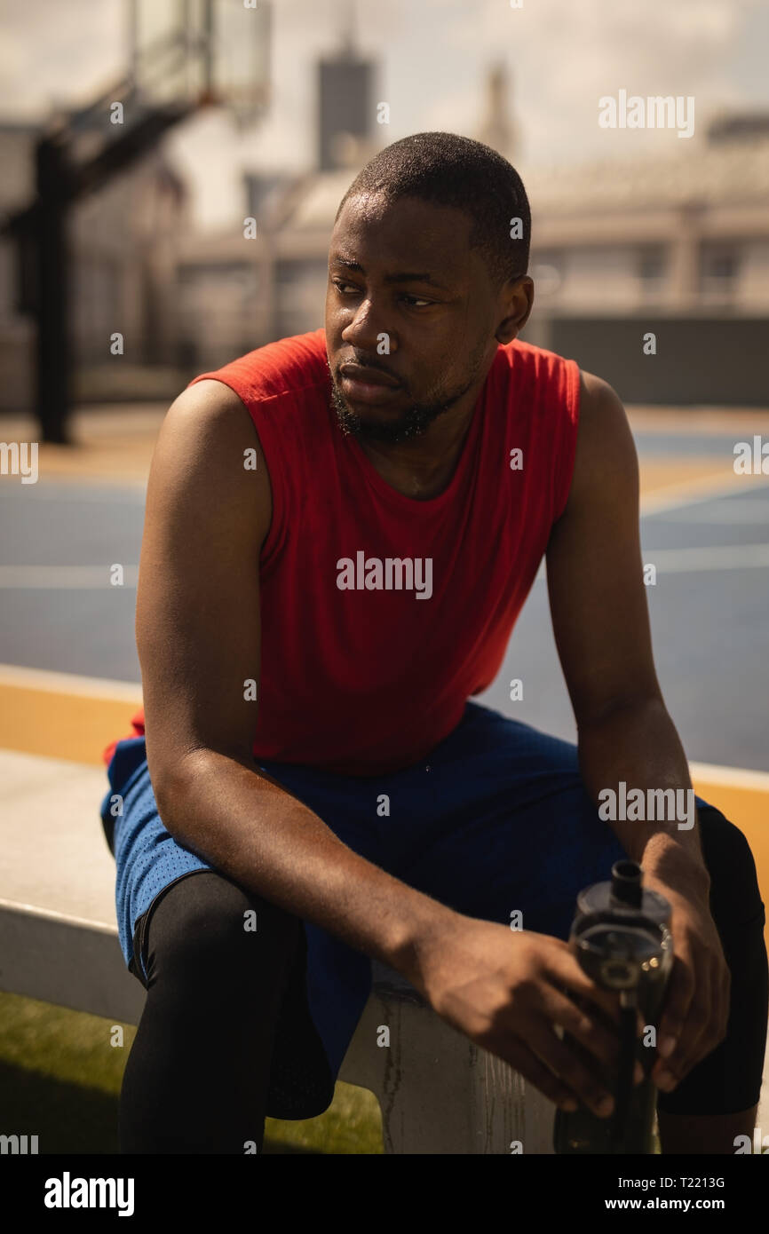 Basketball player relaxing at basketball court Stock Photo - Alamy